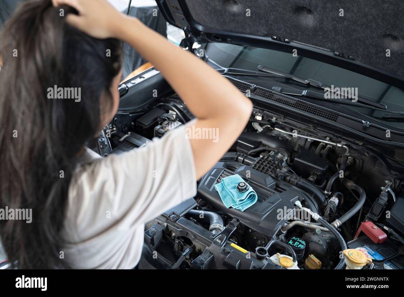 Asian woman having problems with her car Beautiful woman inspecting ...