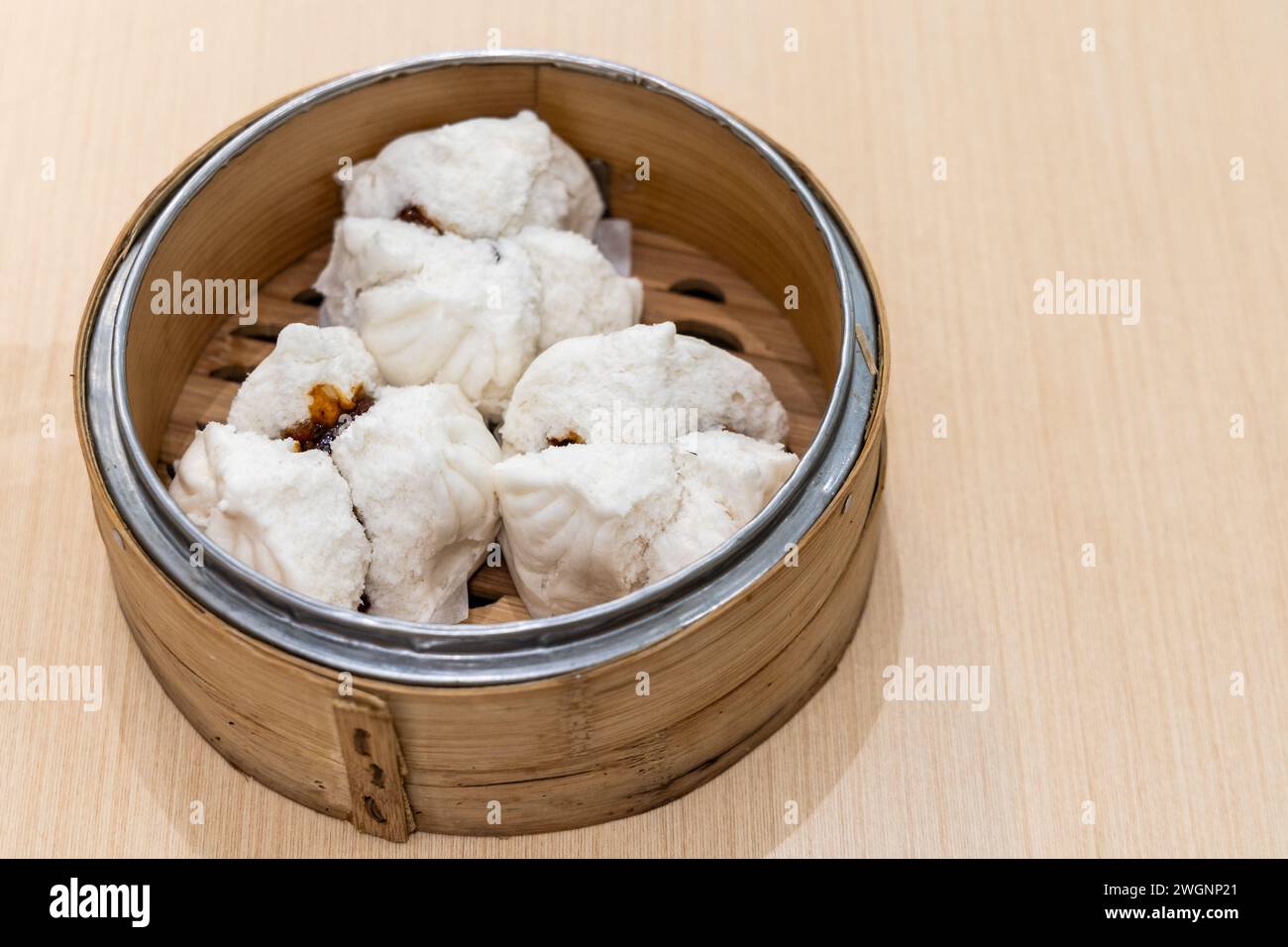 Steamed Char Siew Bao or barbecue pork bun is favorite traditional Chinese dim sum, consumed as ...