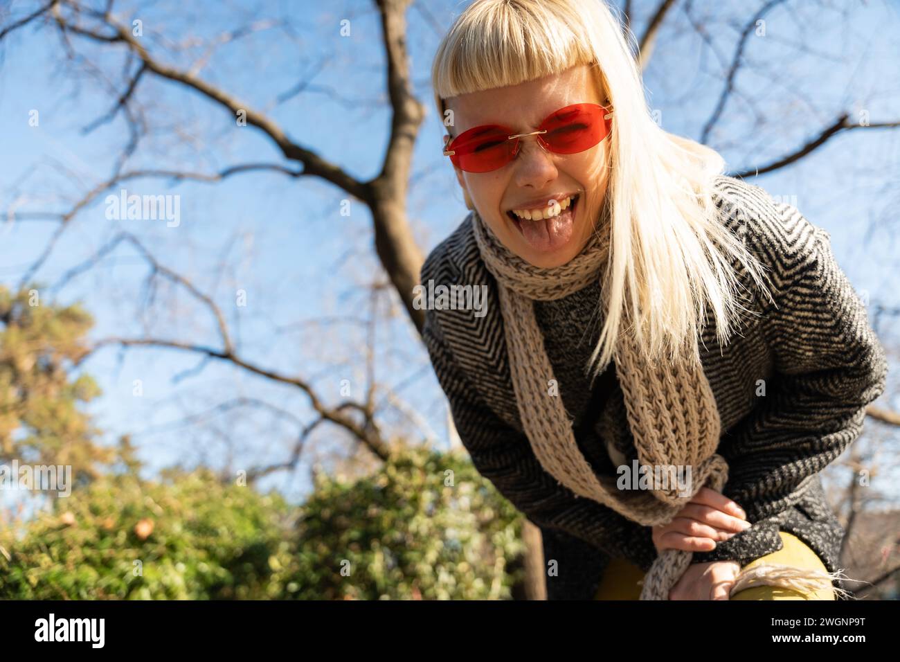 Young happy funny hippie girl showing tongue at camera for fun and ... Young happy funny hippie girl showing tongue at camera for fun and ...