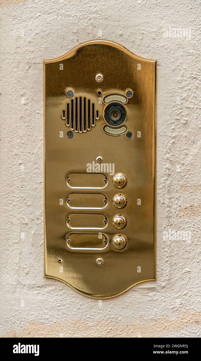Reflective doorbell plate made of brass seen in Italy Stock Photo - Alamy