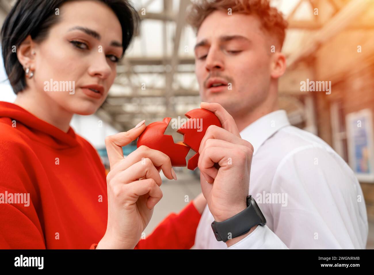 Couple trying to connect two pieces of heart - relationship, in love ...