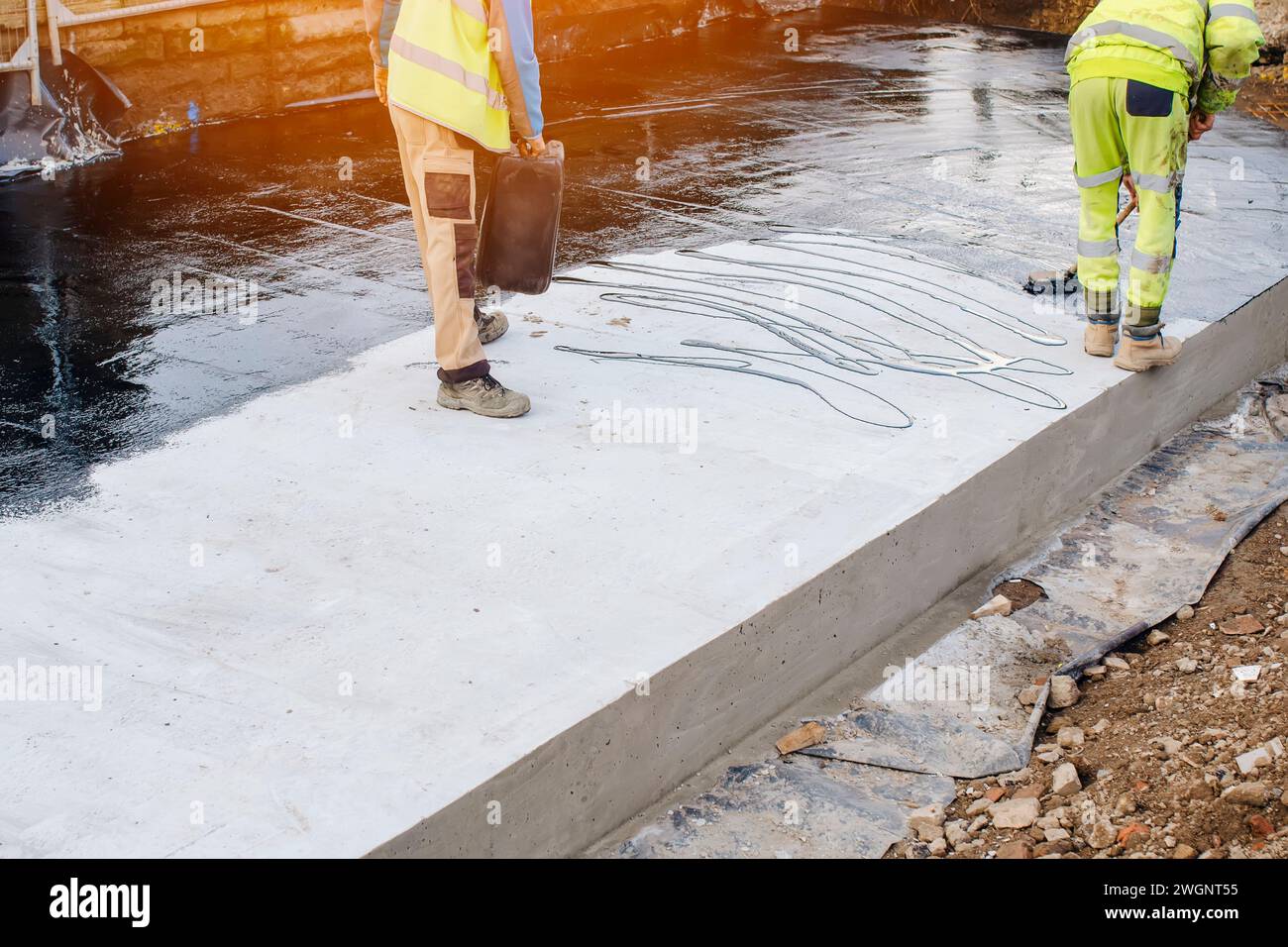 Waterproofing coating. Builder applying waterproofing bitumen mastic on ...