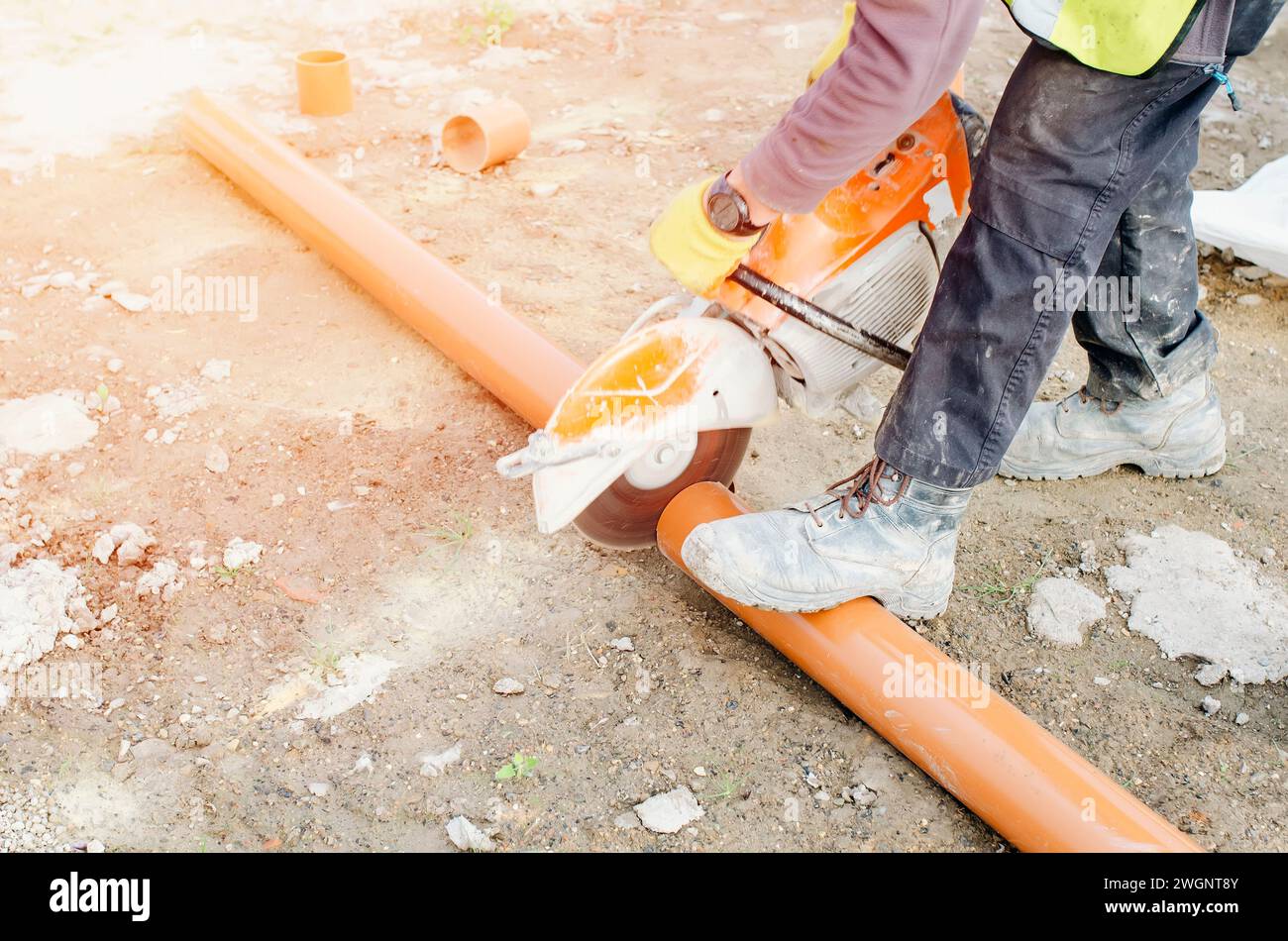 Builder cutting plastic duct with petrol saw Stock Photo - Alamy Builder cutting plastic duct with petrol saw Stock Photo - Alamy