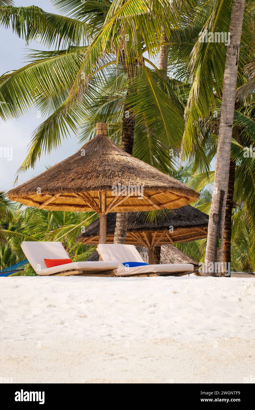 Wooden beach parasol and beach loungers at sunset.Luxury beach umbrella ...