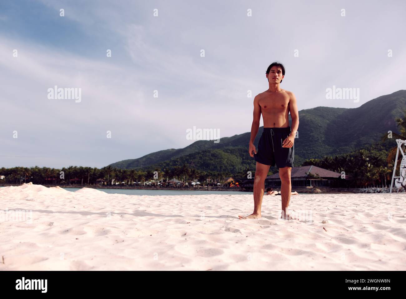 Strong Asian Athlete Embracing the Beach: Man Running on Sand with ...