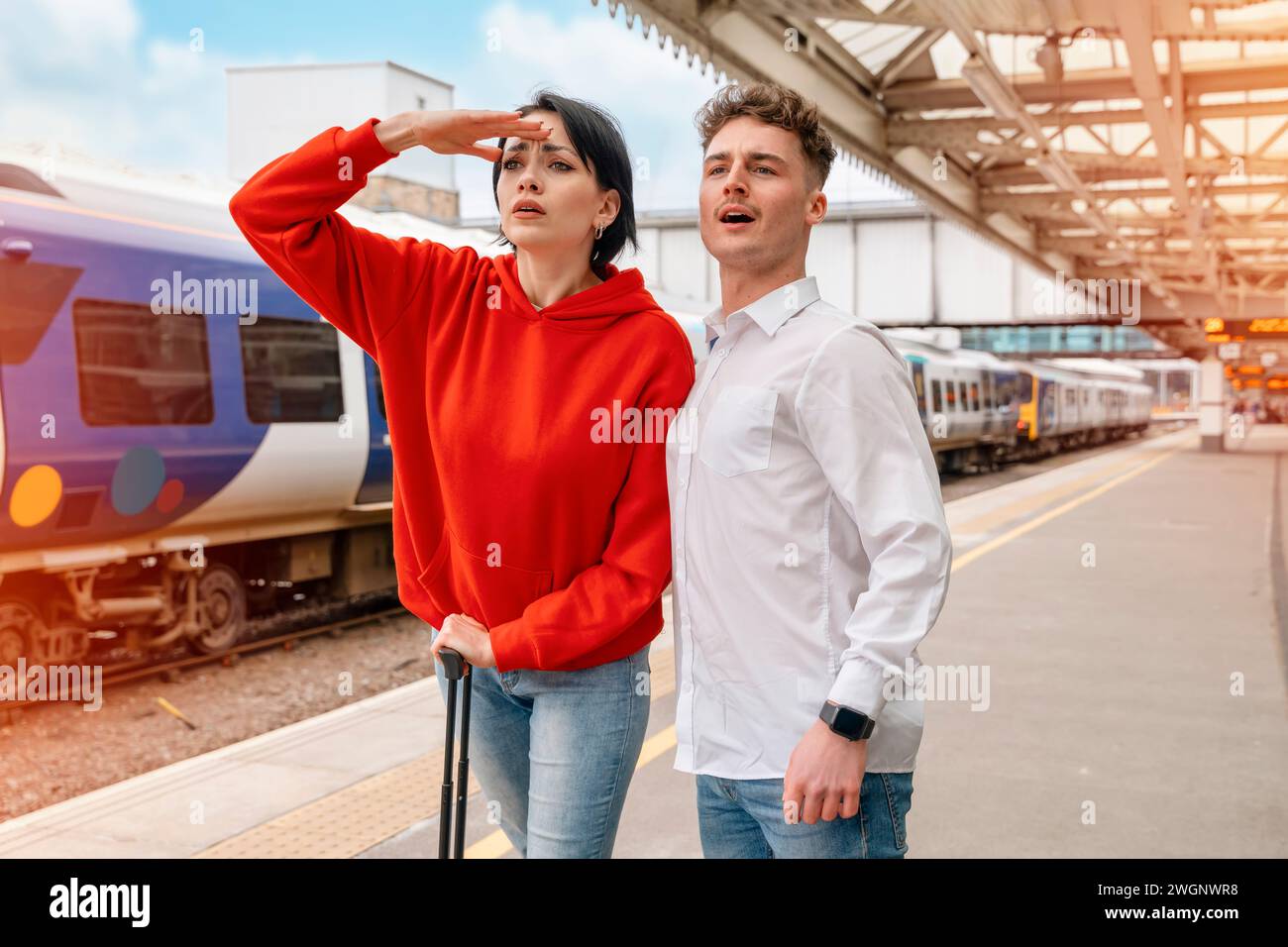 Beautiful couple at railway station waiting for the train. Woman and ...