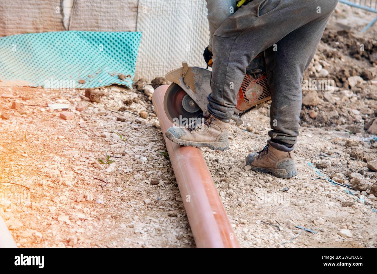 Laying plastic drainage pipes into the ground as part of new drainage ...