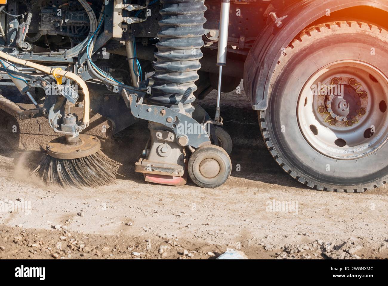 Road sweeper cleaning road next to a construction site Stock Photo - Alamy