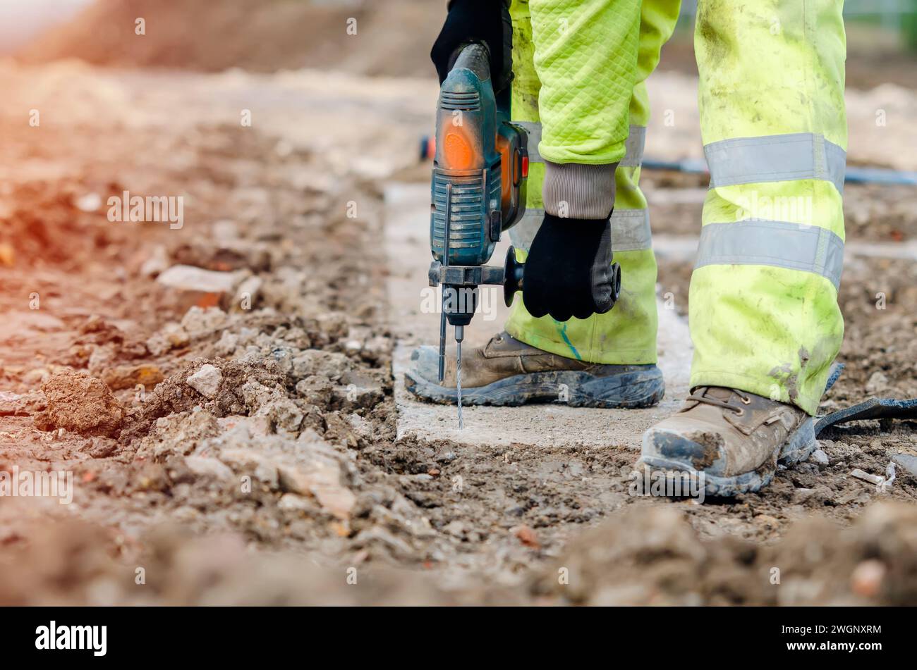 Builder drilling through hard concrete with a cordless drill Stock ...