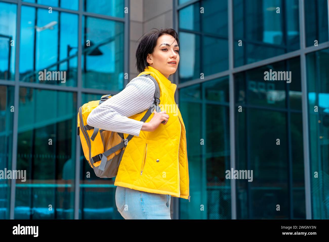 glad young woman holding backpack. woman enjoys vacation Passenger ...