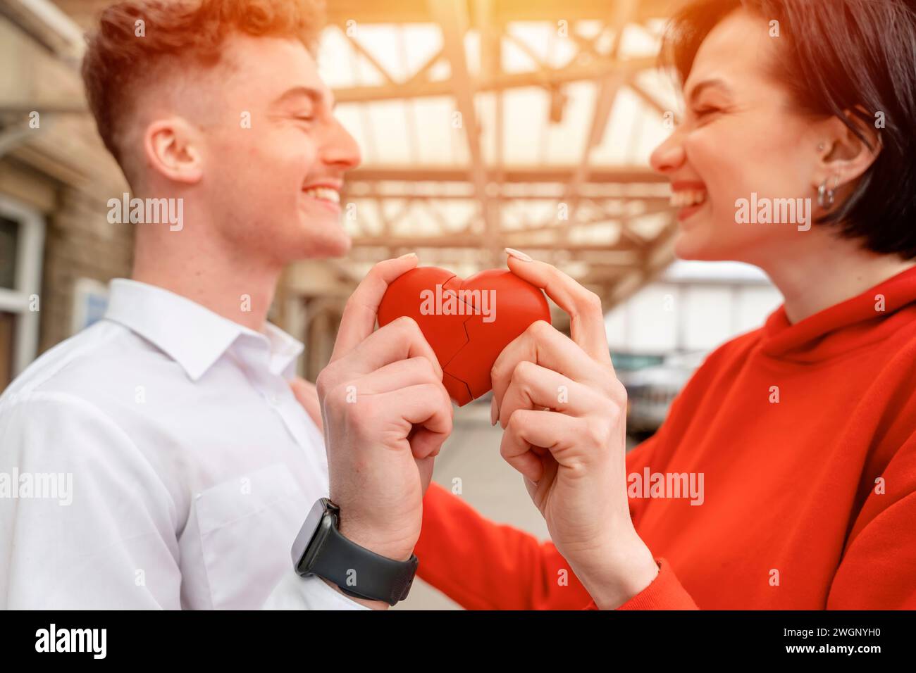 Happy Couple trying to connect two pieces of heart - relationship, in ...
