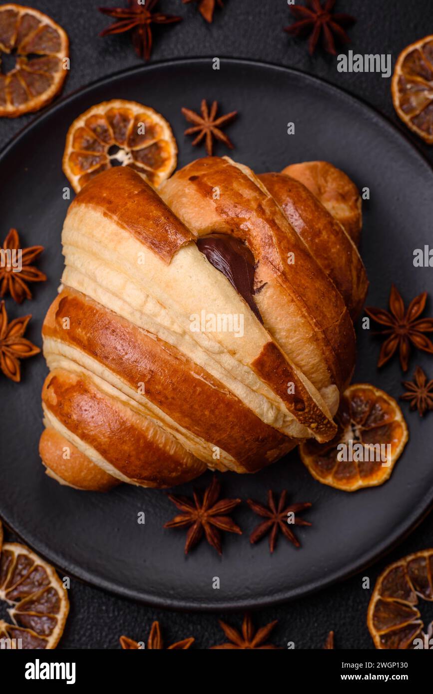 Delicious crispy sweet croissant cornet with chocolate on a dark ...