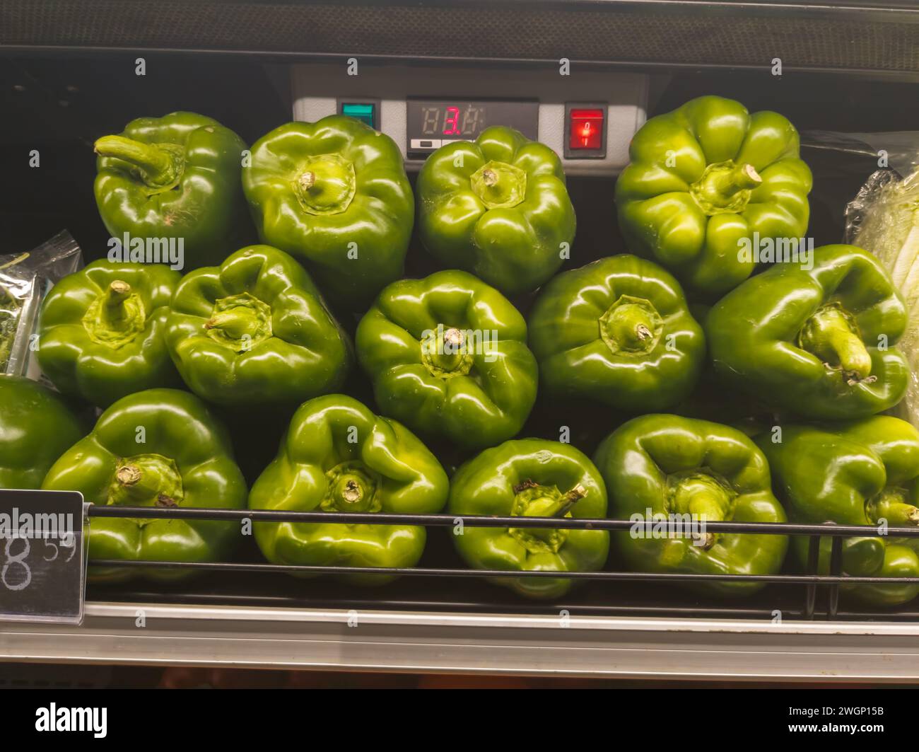 green peppers at vegetable rack in supermarket Stock Photo - Alamy