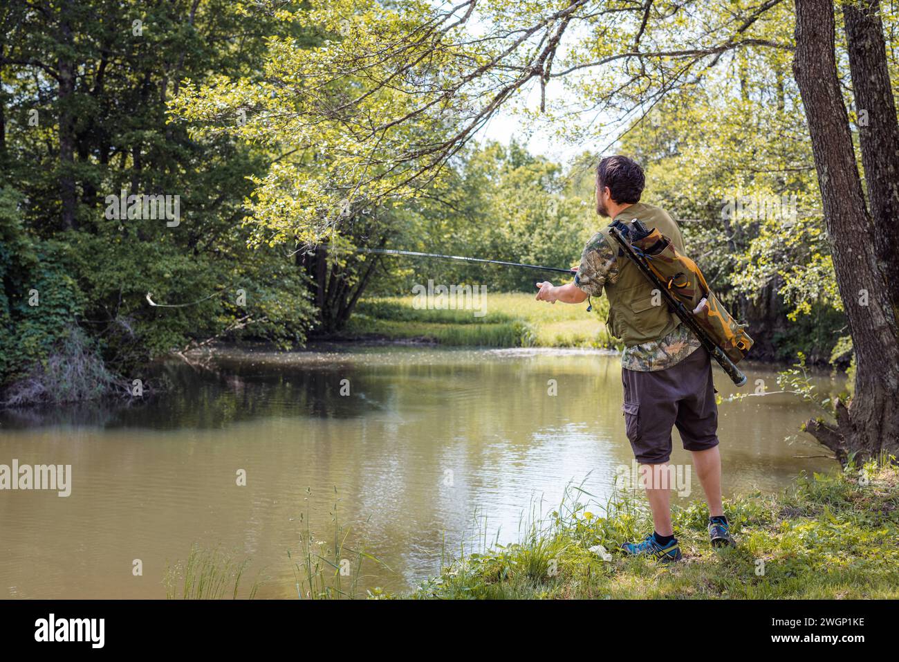 Recreational fisherman at river bank trying to catch a fish. Angler ...