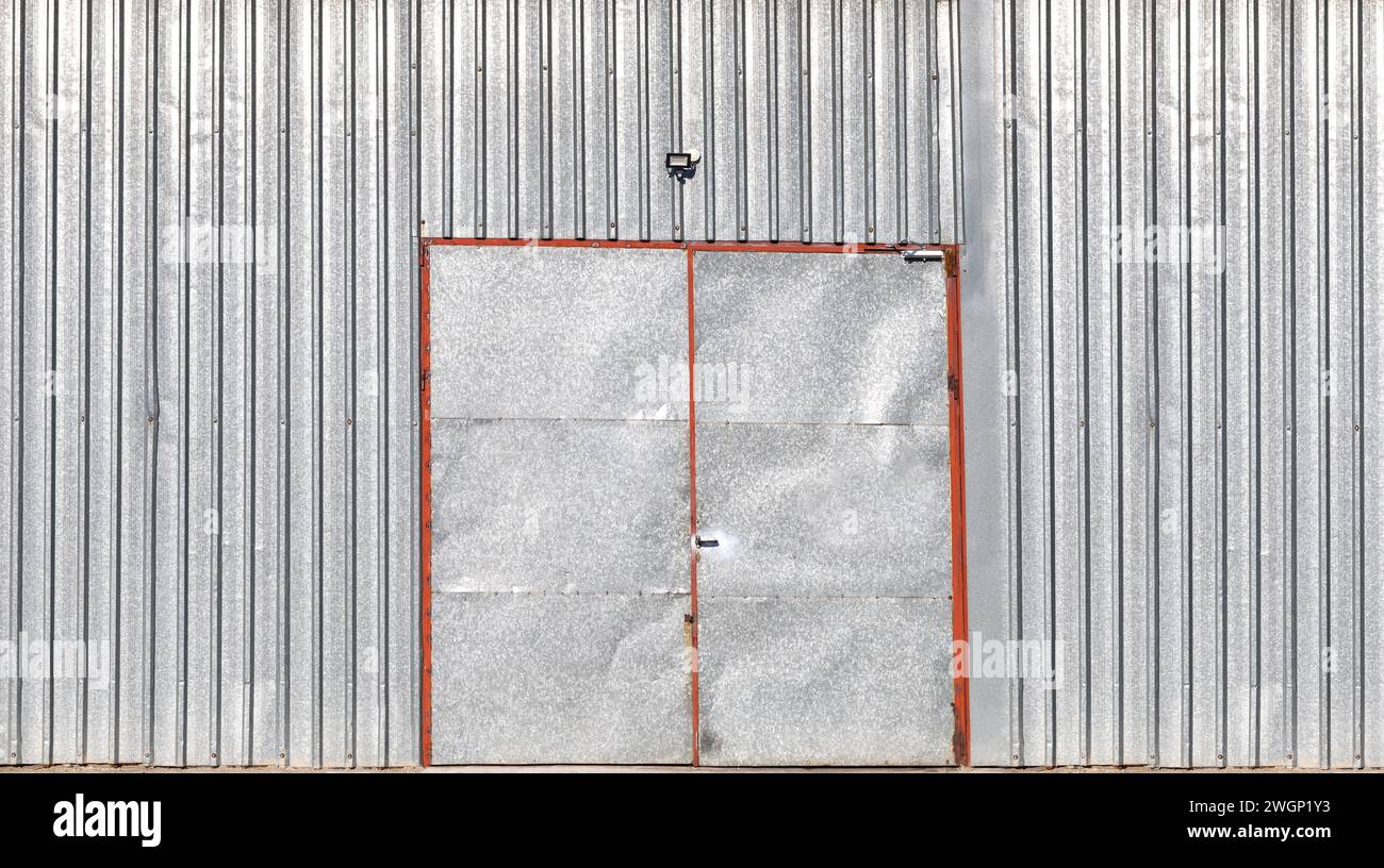 corrugated aluminum warehouse with door material Stock Photo - Alamy