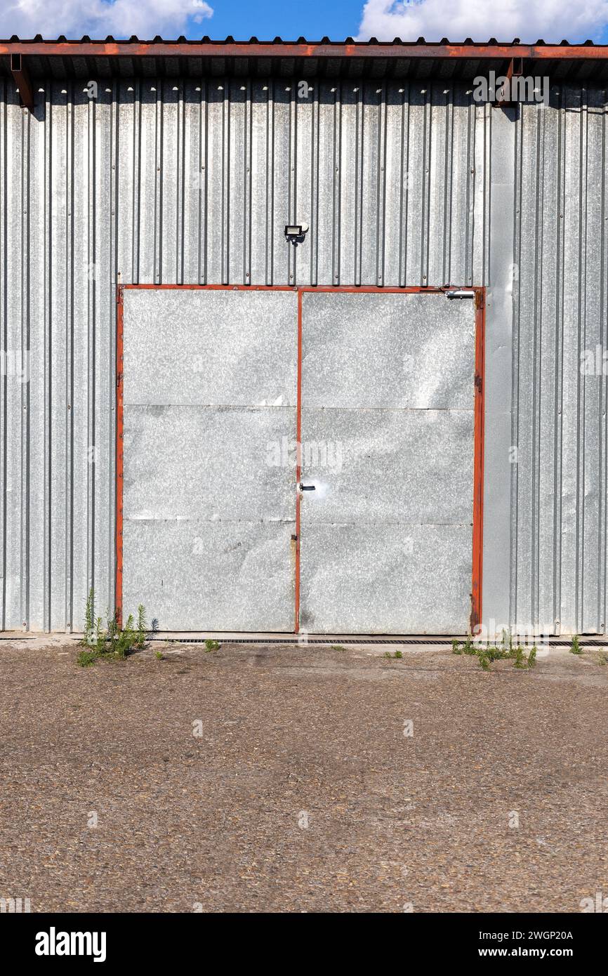 corrugated aluminum warehouse with door material Stock Photo - Alamy