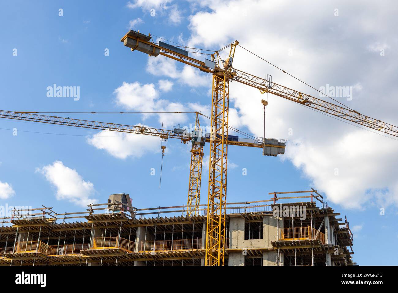construction cranes working on new low rise building Stock Photo - Alamy