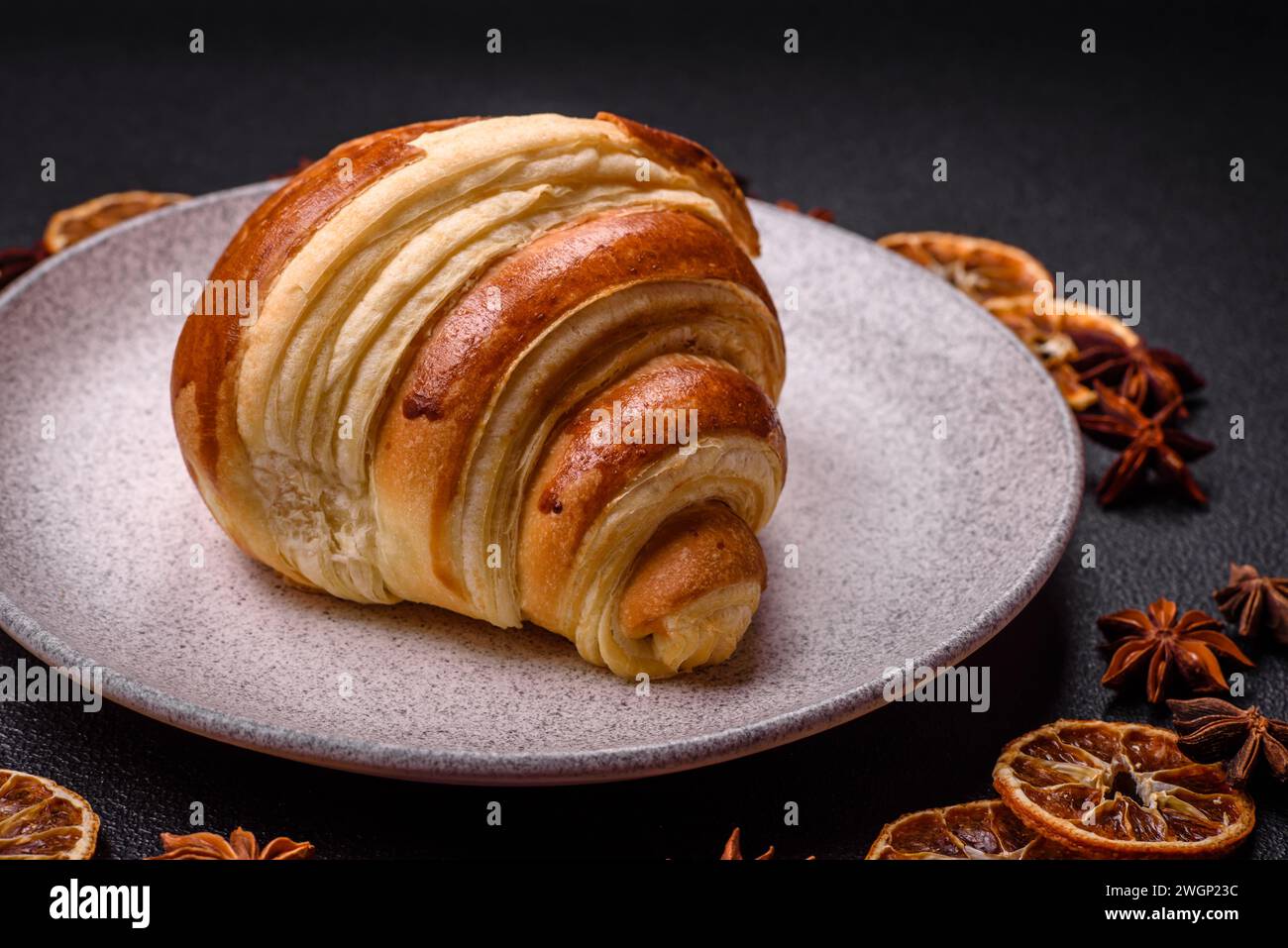 Delicious crispy sweet croissant cornet with chocolate on a dark ...
