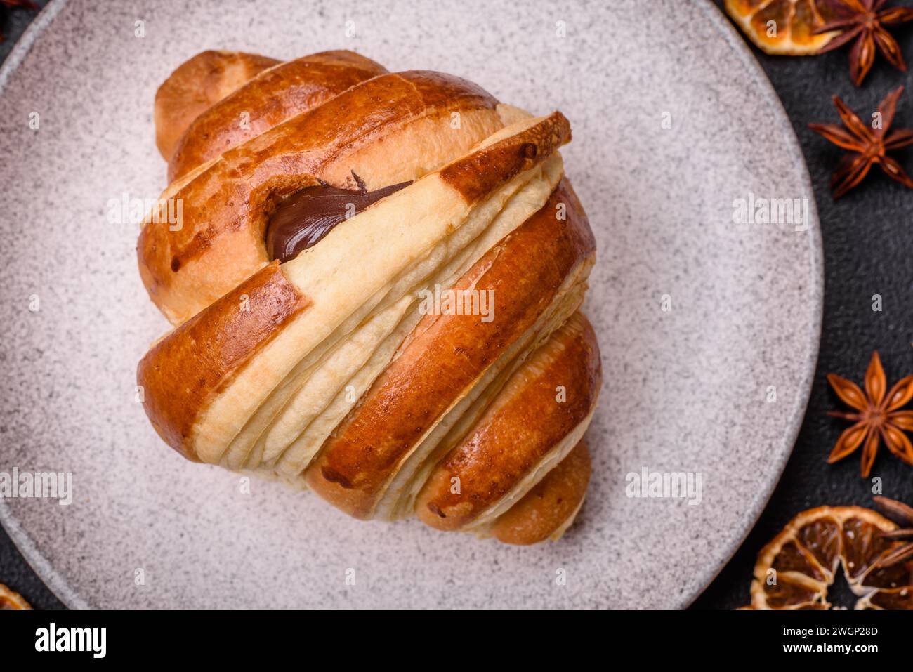 Delicious crispy sweet croissant cornet with chocolate on a dark ...