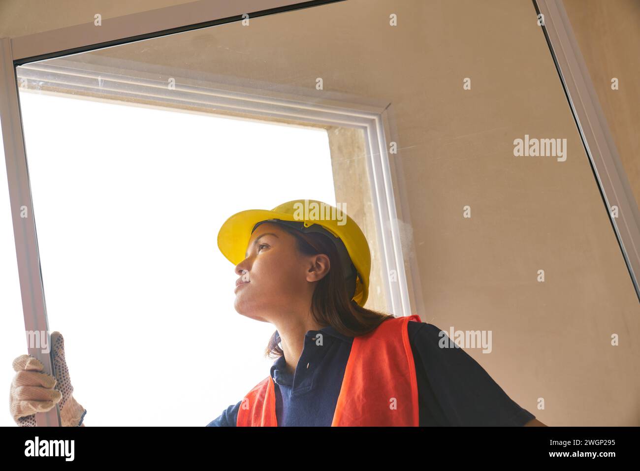 Female construction worker installing window frame Stock Photo - Alamy