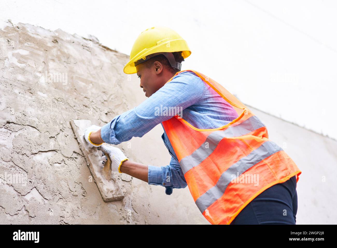 Female labor plastering on wall with cement Stock Photo - Alamy