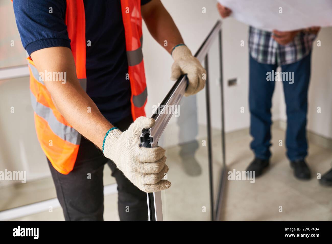 Male carpenter installing window Stock Photo - Alamy