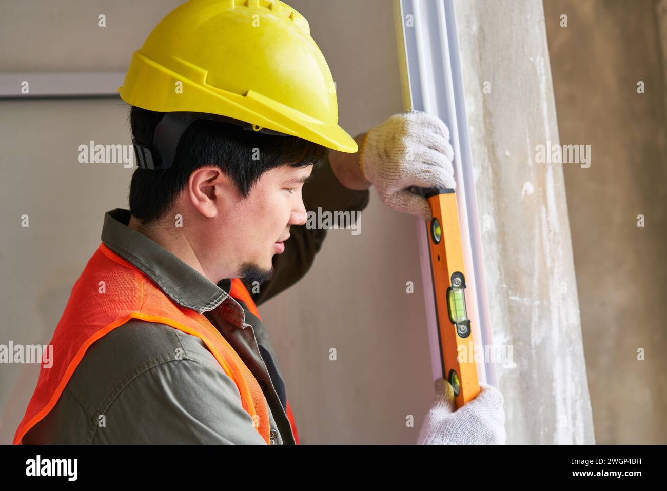 Male worker examining frame with level Stock Photo - Alamy