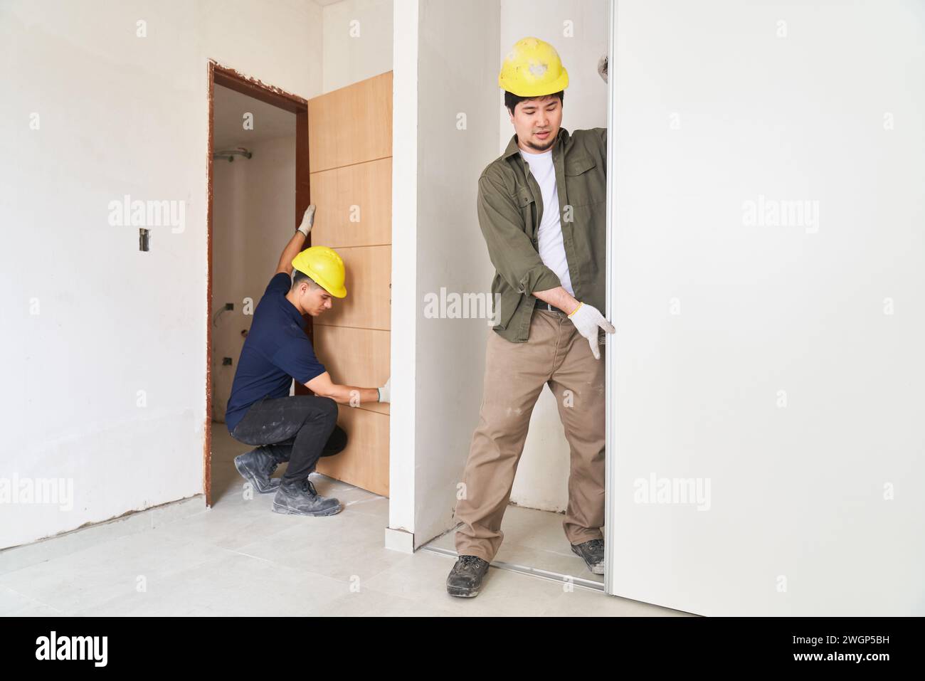 Construction workers fitting safety hi-res stock photography and images ...