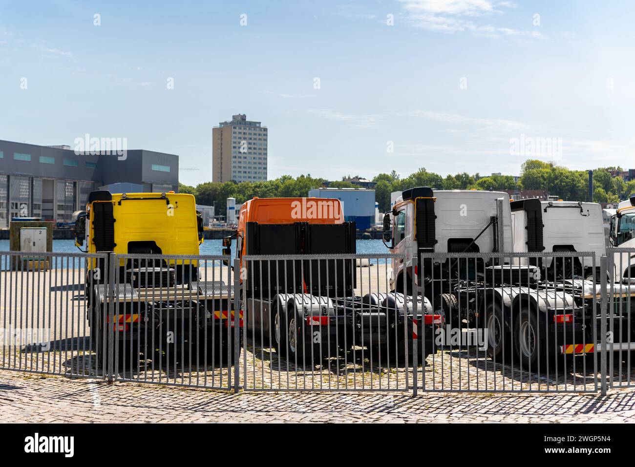 Back view many new heavy commercial cargo transport vehicles stand at ...
