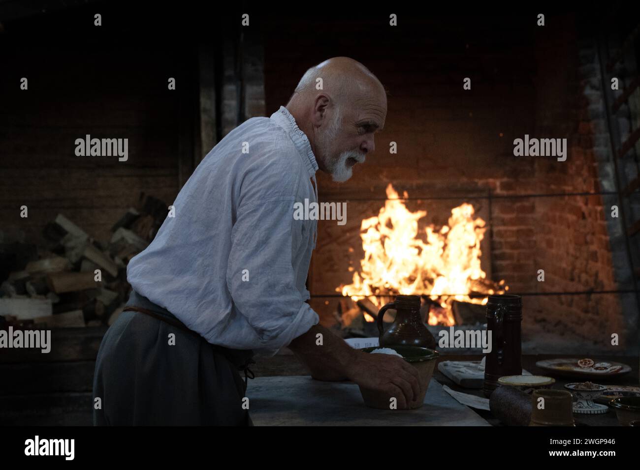 Hampton court Palace England August 1st 2023 a tudor chef preparing a ...