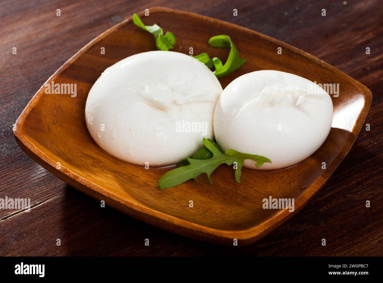 Italian cheese burrata with fresh arugula Stock Photo - Alamy
