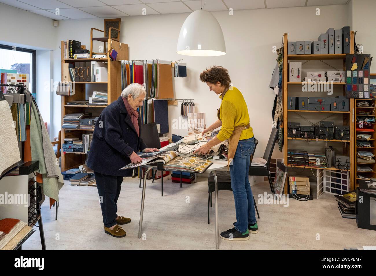 Female upholstery helping client select fabric Stock Photo - Alamy