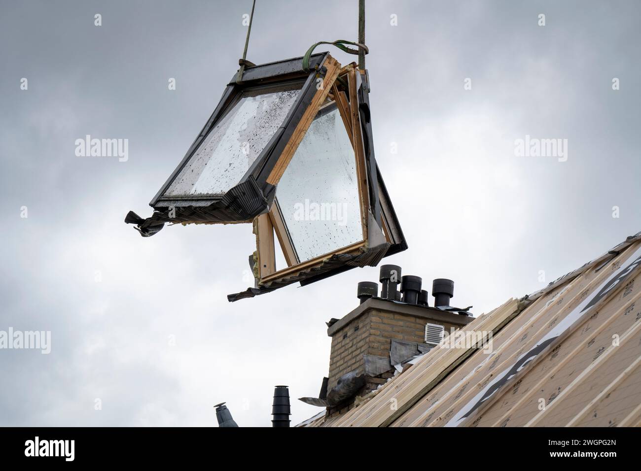 Windows being lifted into position over a new roof Stock Photo - Alamy