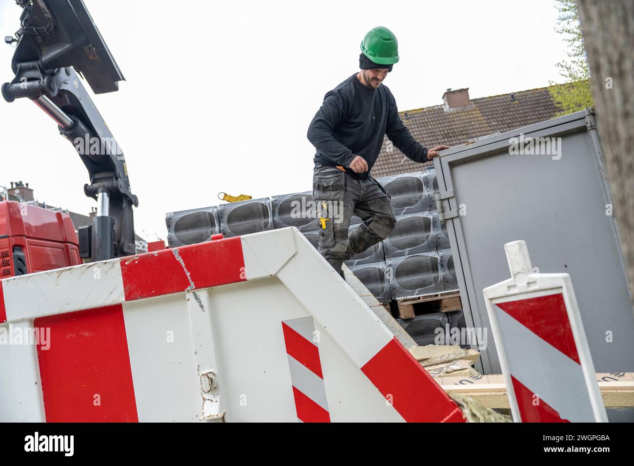 Tradesman jumping over a barrier Stock Photo - Alamy
