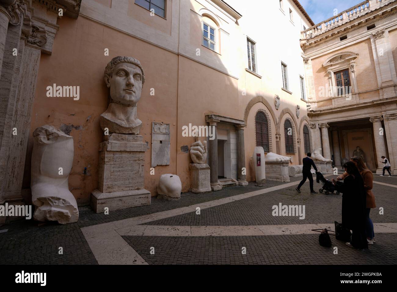 People admire the surviving portions of the statue of Roman emperor ...