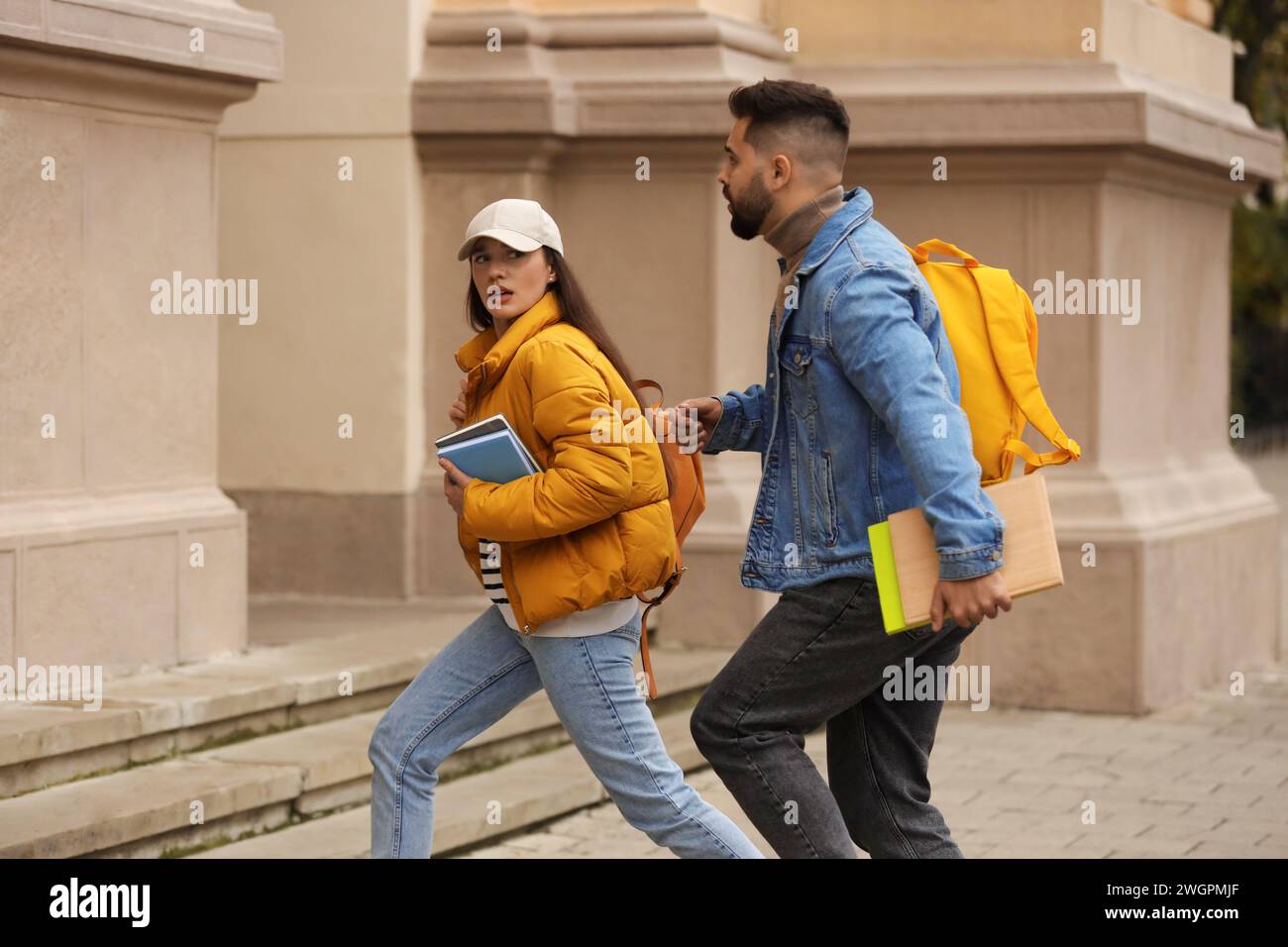 Being late. Students running towards building outdoors Stock Photo - Alamy