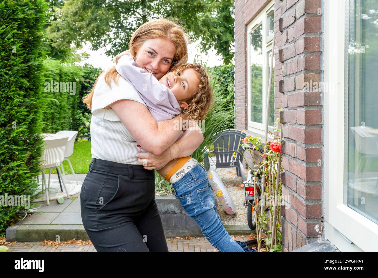 Back view three women hugging hi-res stock photography and images - Alamy