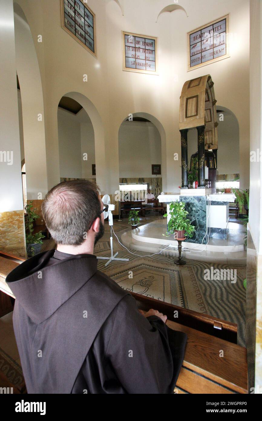 A Franciscan monk prays at the Church of the Beatitudes, the ...