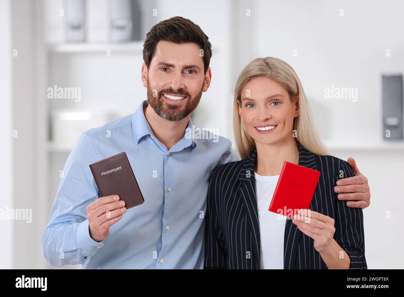Immigration. Happy man and woman with passports indoors Stock Photo - Alamy