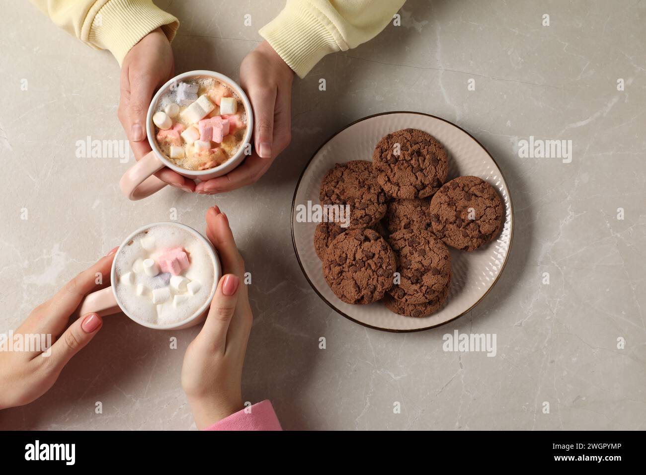 Women having coffee break at marble table, top view Stock Photo - Alamy