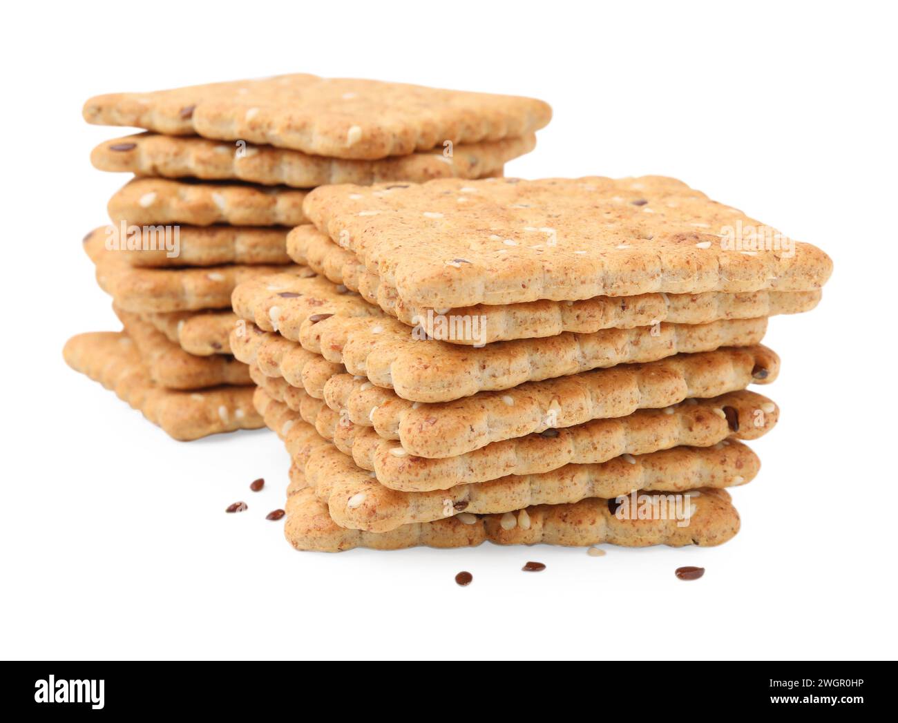 Stacks of cereal crackers with flax and sesame seeds isolated on white ...