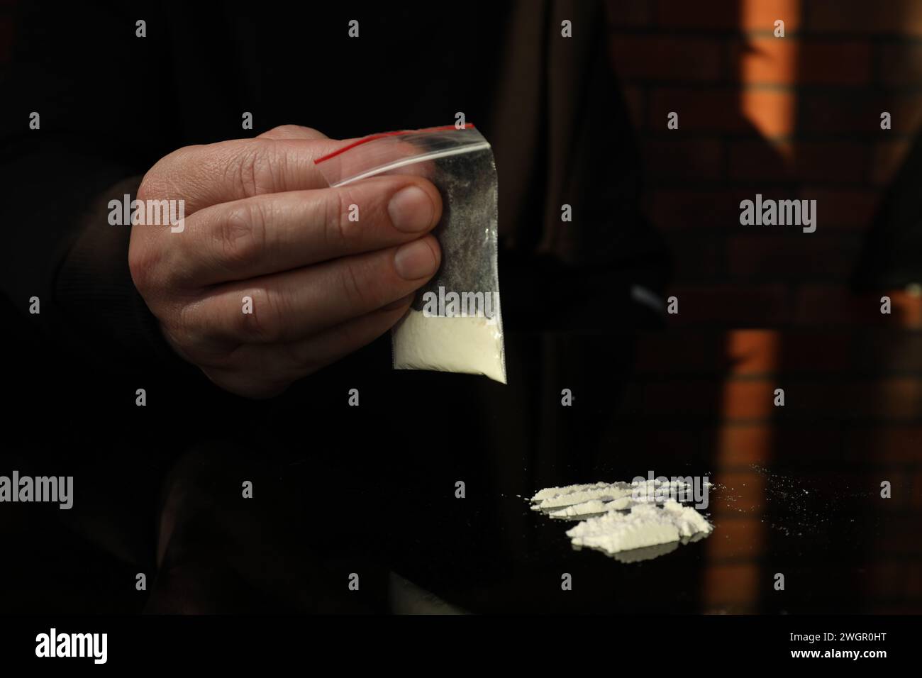 Drug addiction. Man with cocaine at black table, closeup Stock Photo ...