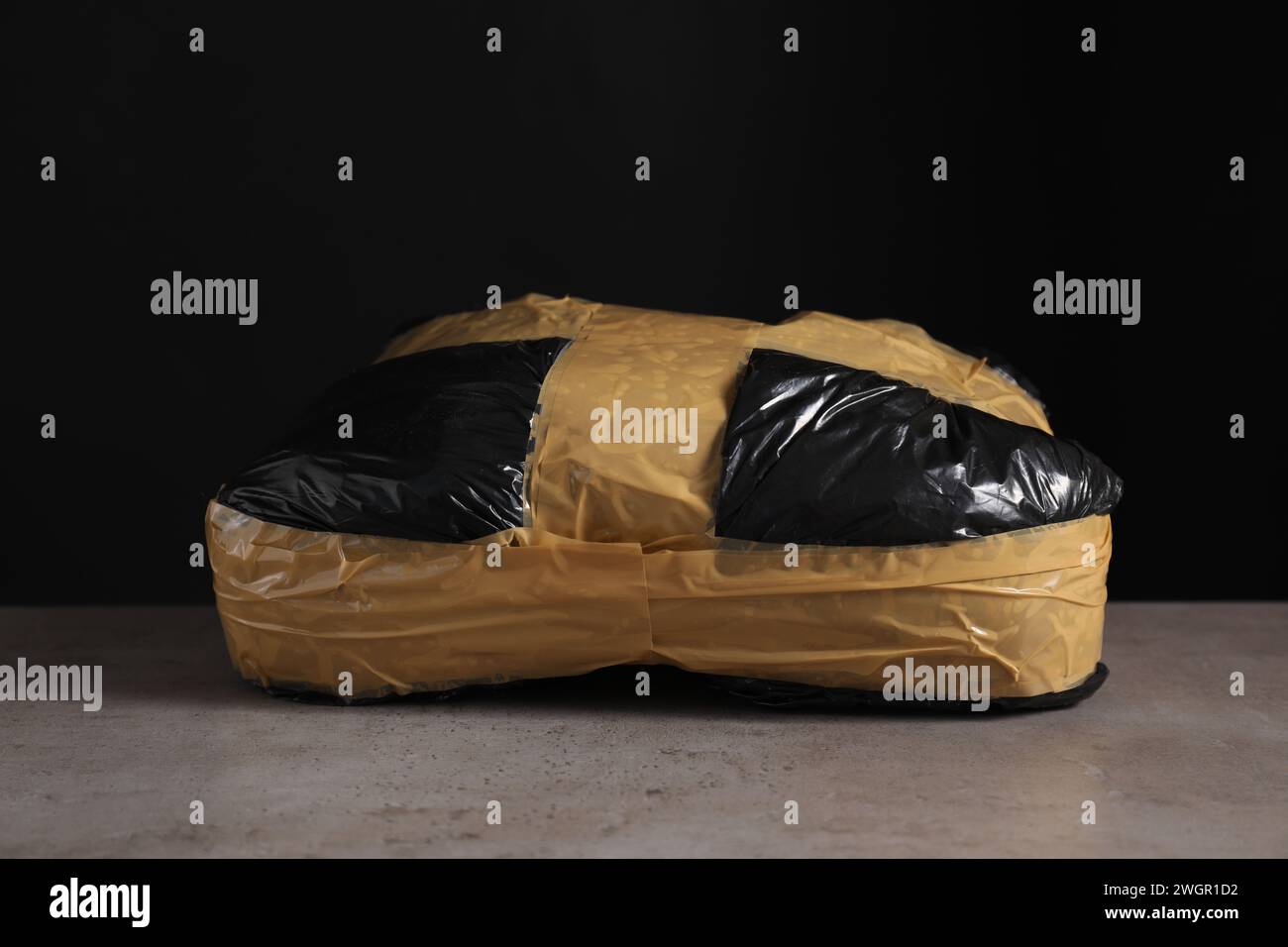 Smuggling and drug trafficking. Package with narcotics on grey table ...