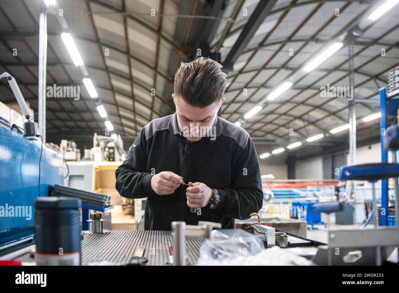 Holding standing looking down work tool skill hi-res stock photography ...