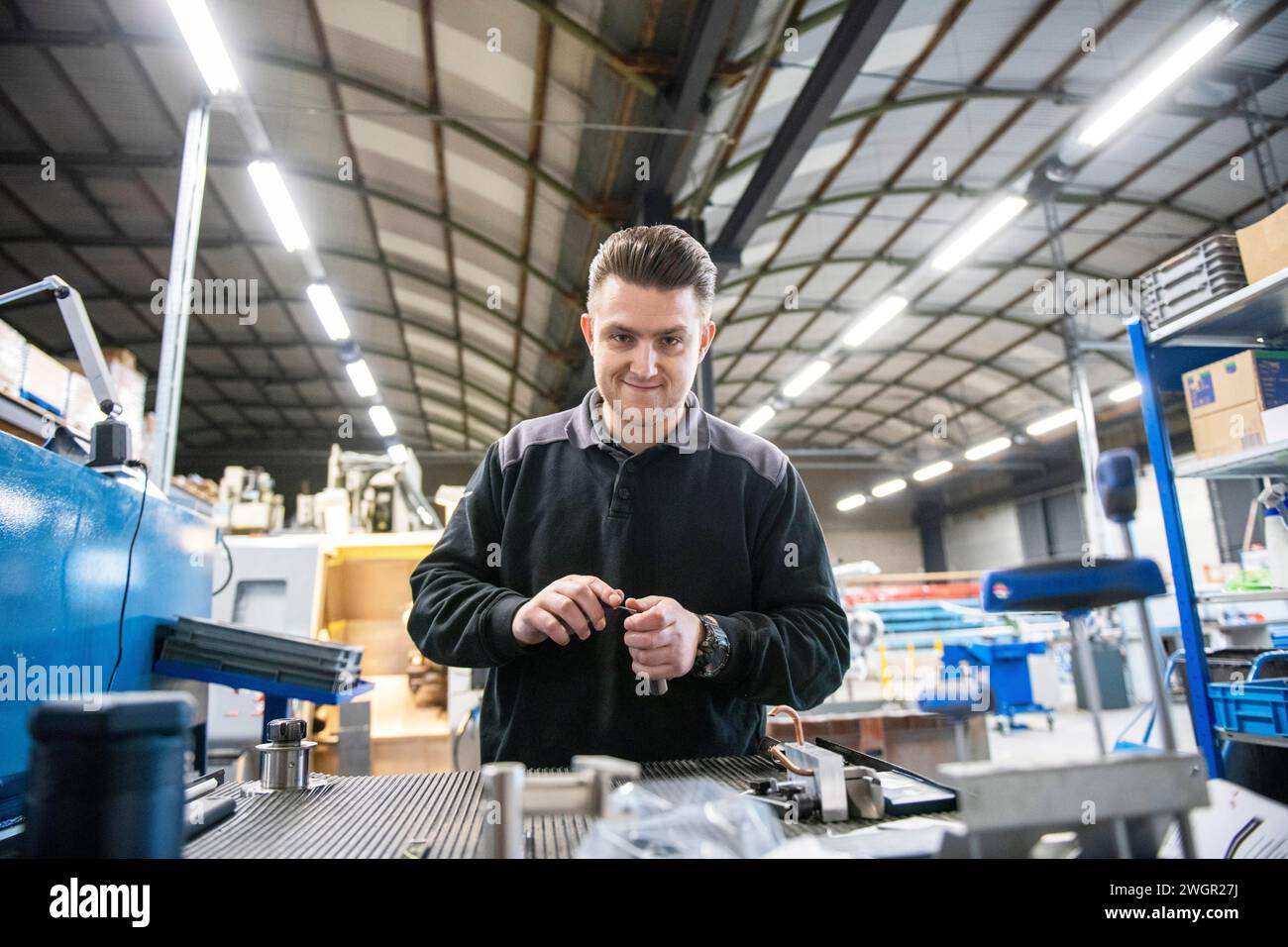 Young mechanical engineer working on steel machinery in a factory Stock ...