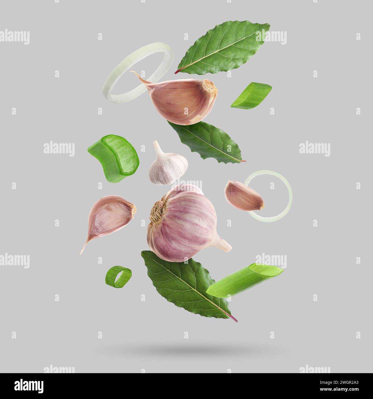 Different spices falling on light grey background Stock Photo - Alamy