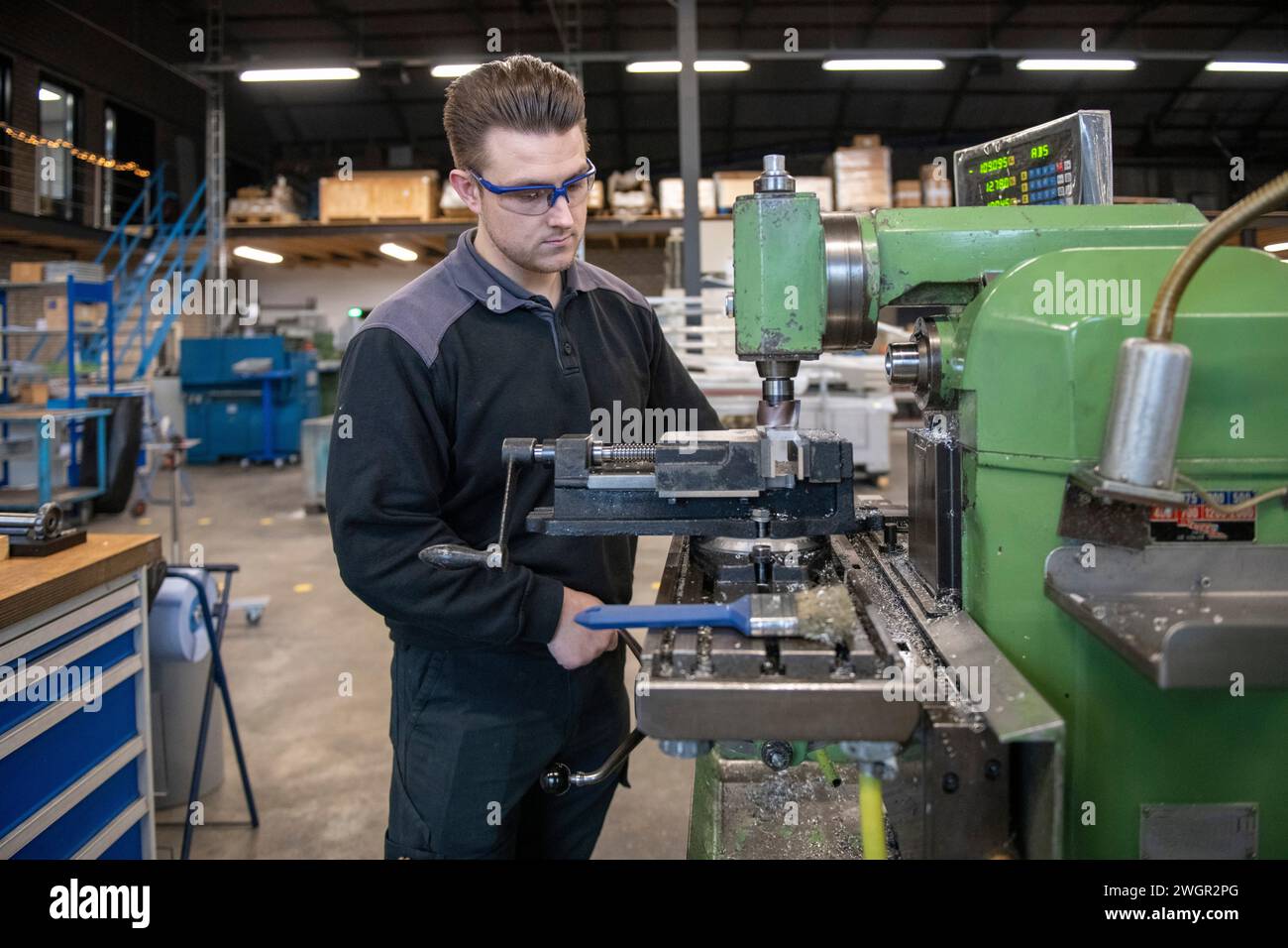 Young mechanical engineer working on steel machinery in a factory Stock ...