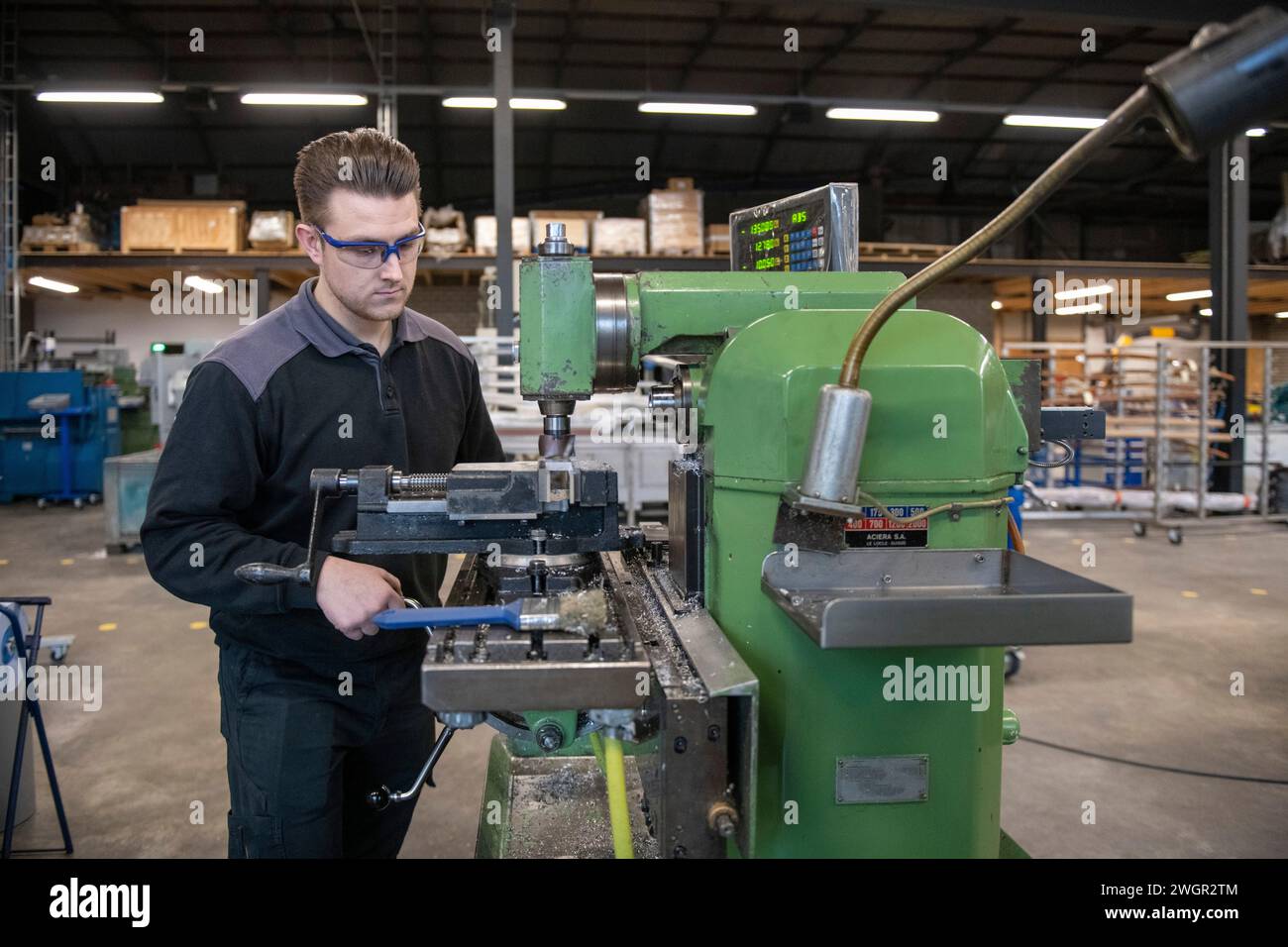 Young mechanical engineer working on steel machinery in a factory Stock ...