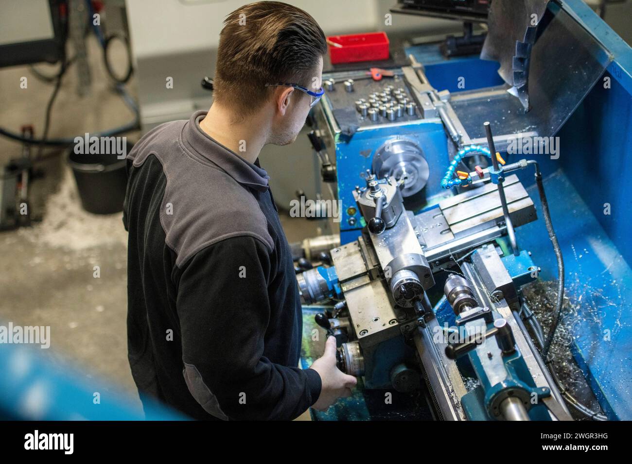 Young mechanical engineer working on steel machinery in a factory Stock ...