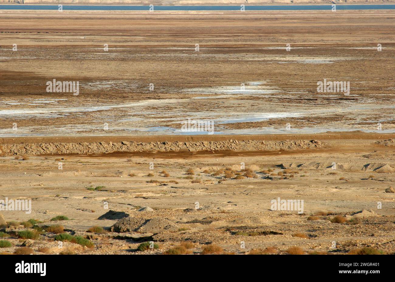 A sinkhole caused by the receding water level of the Dead Sea. A hot ...